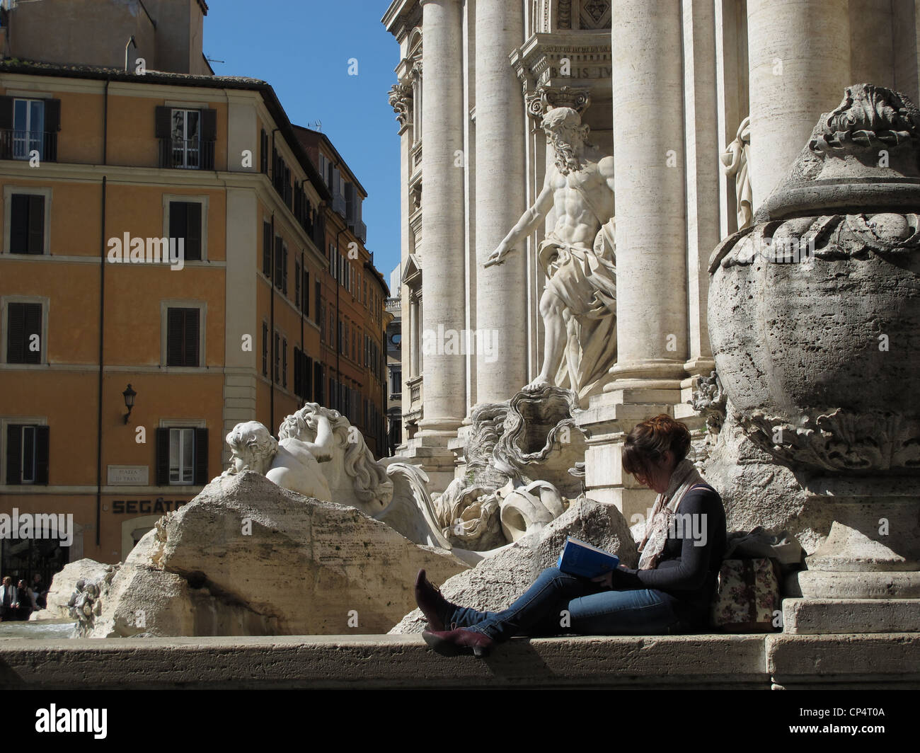 young woman reading book by the trevi fountain in rome italy Stock ...