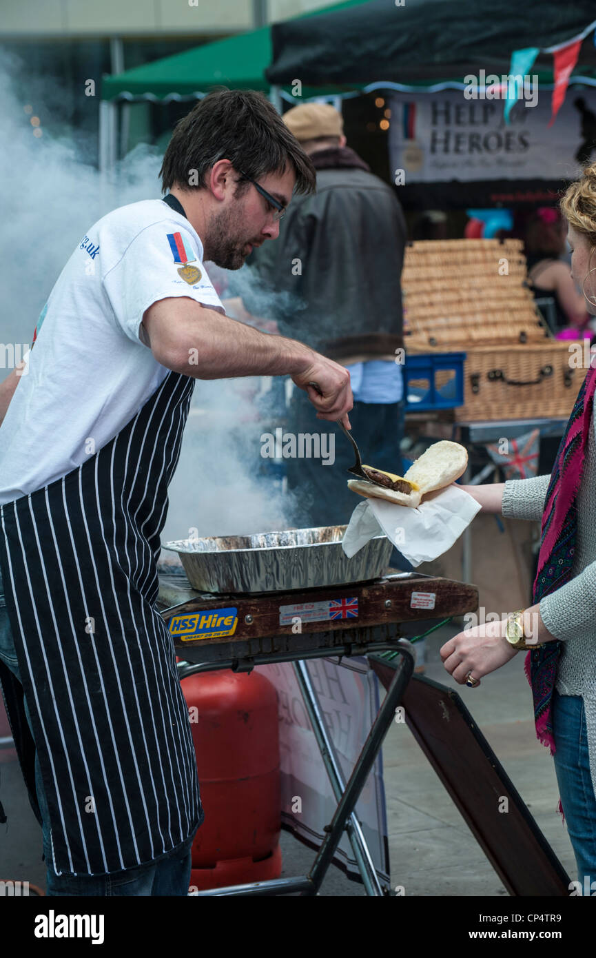 Man cooking on a smoking barbeque at the Help for Heroes charity stand ...