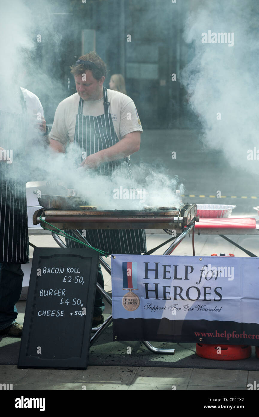 Man cooking on a smoking barbeque at the Help for Heroes charity stand ...