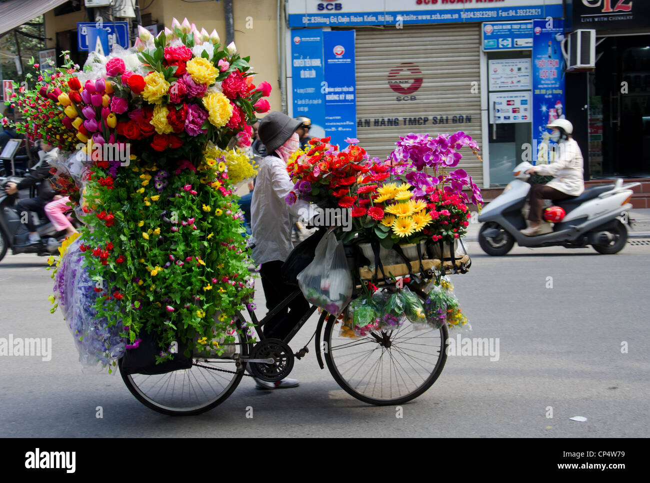 With flower an overloaded bicycle Stock Photo - Alamy