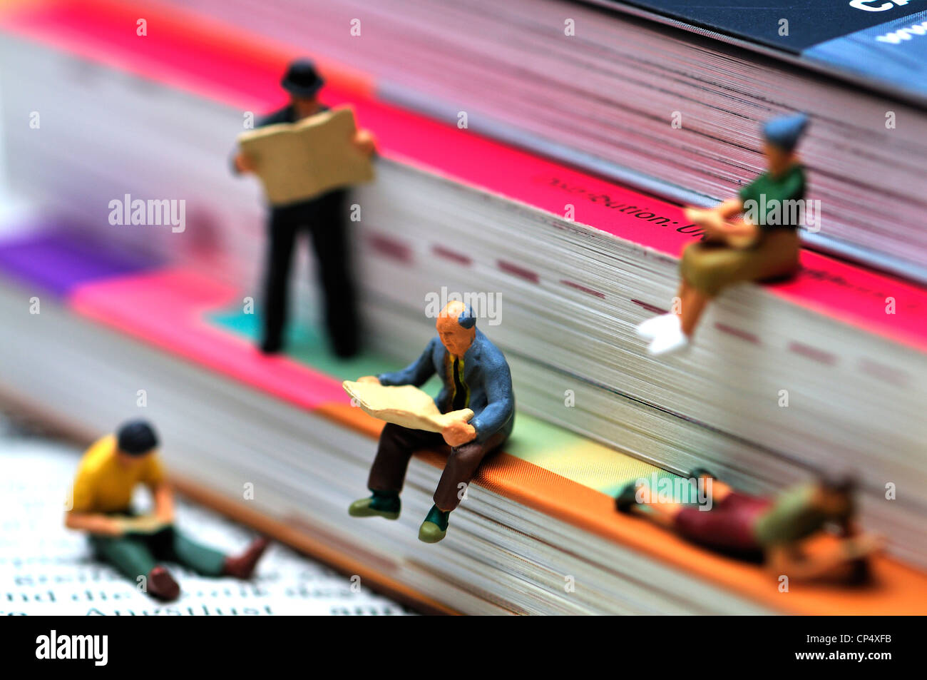 People reading - sitting and standing on books Stock Photo - Alamy
