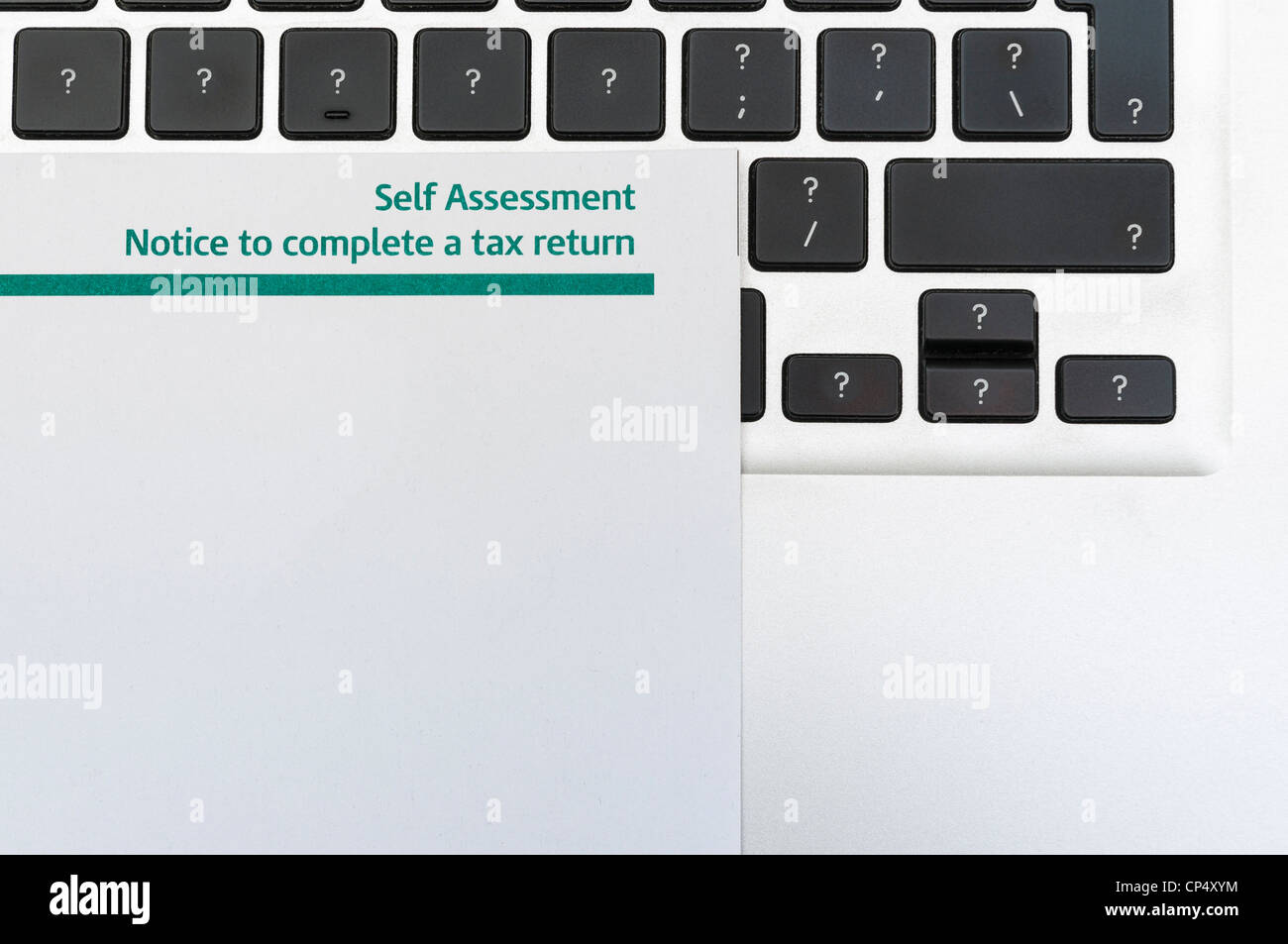 Detail of blank tax return form on top of computer keyboard with ...