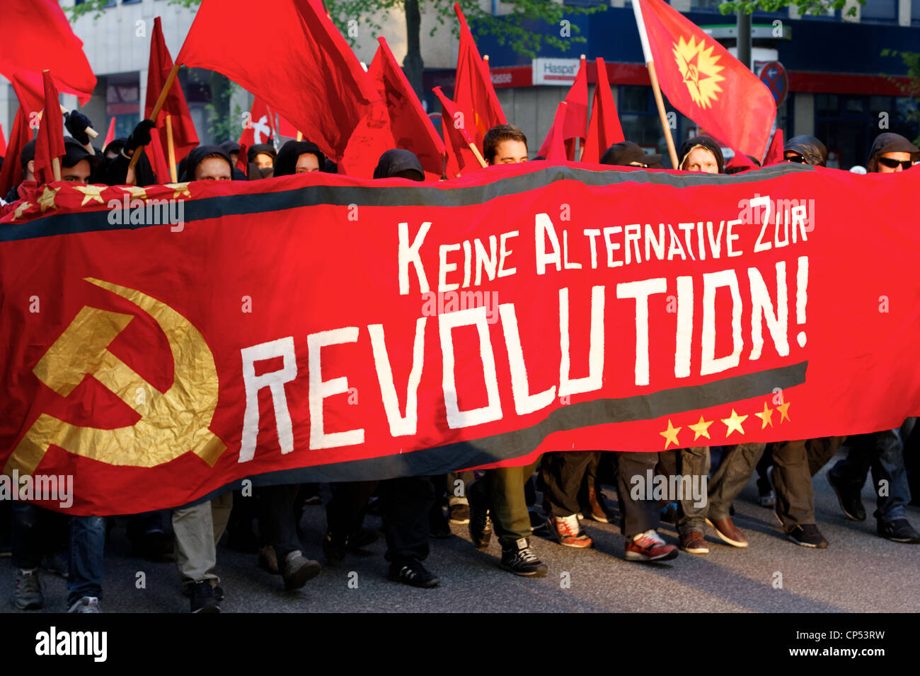 Protesters carry a red banner demanding revolution at the May Day ...