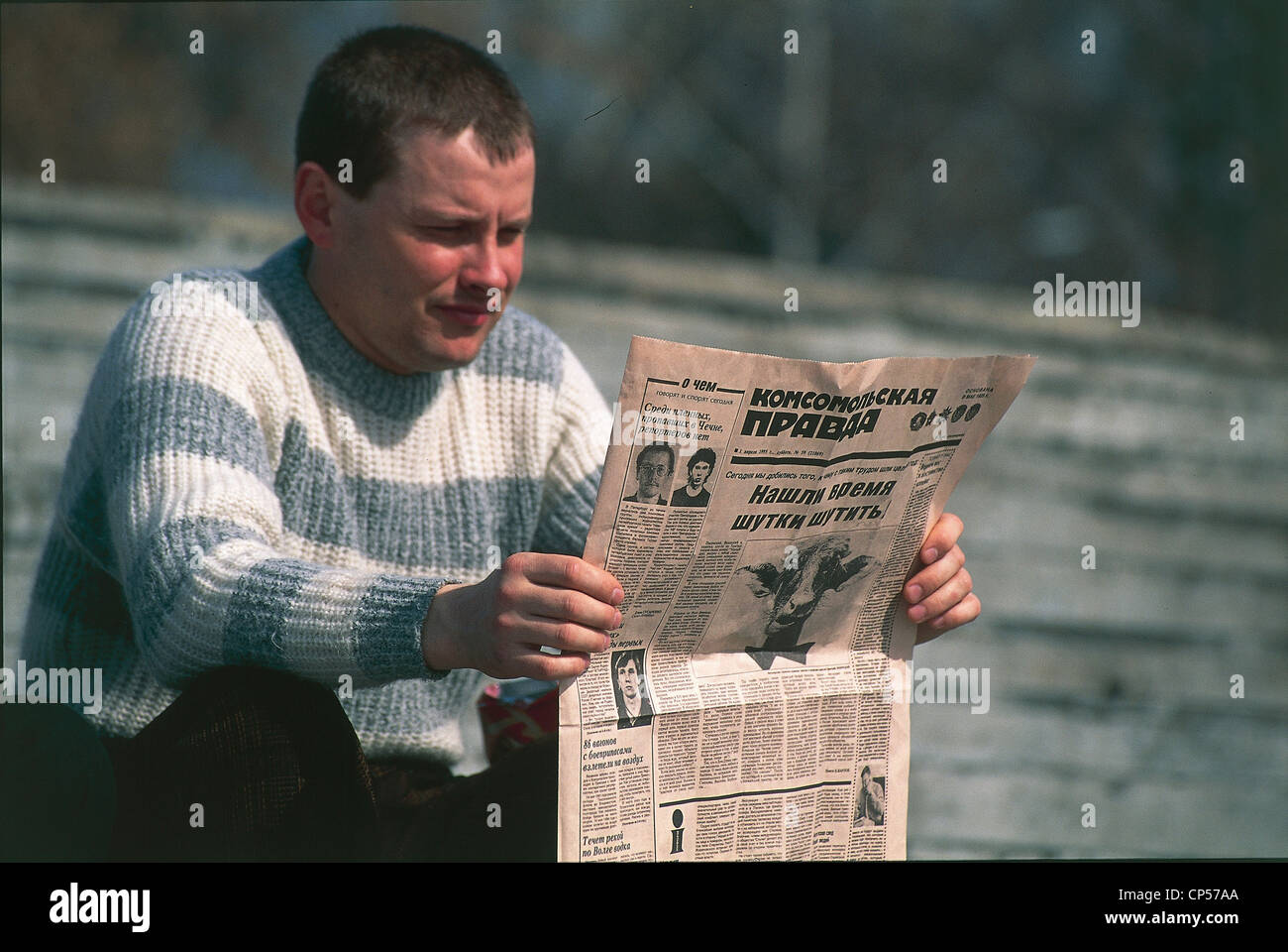 Russia XX century. Nineties - Siberia - Irkutsk. Man reading the ...