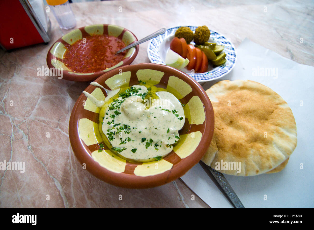 Hummus Masabacha served with pita bread, veggies and Falafel balls ...
