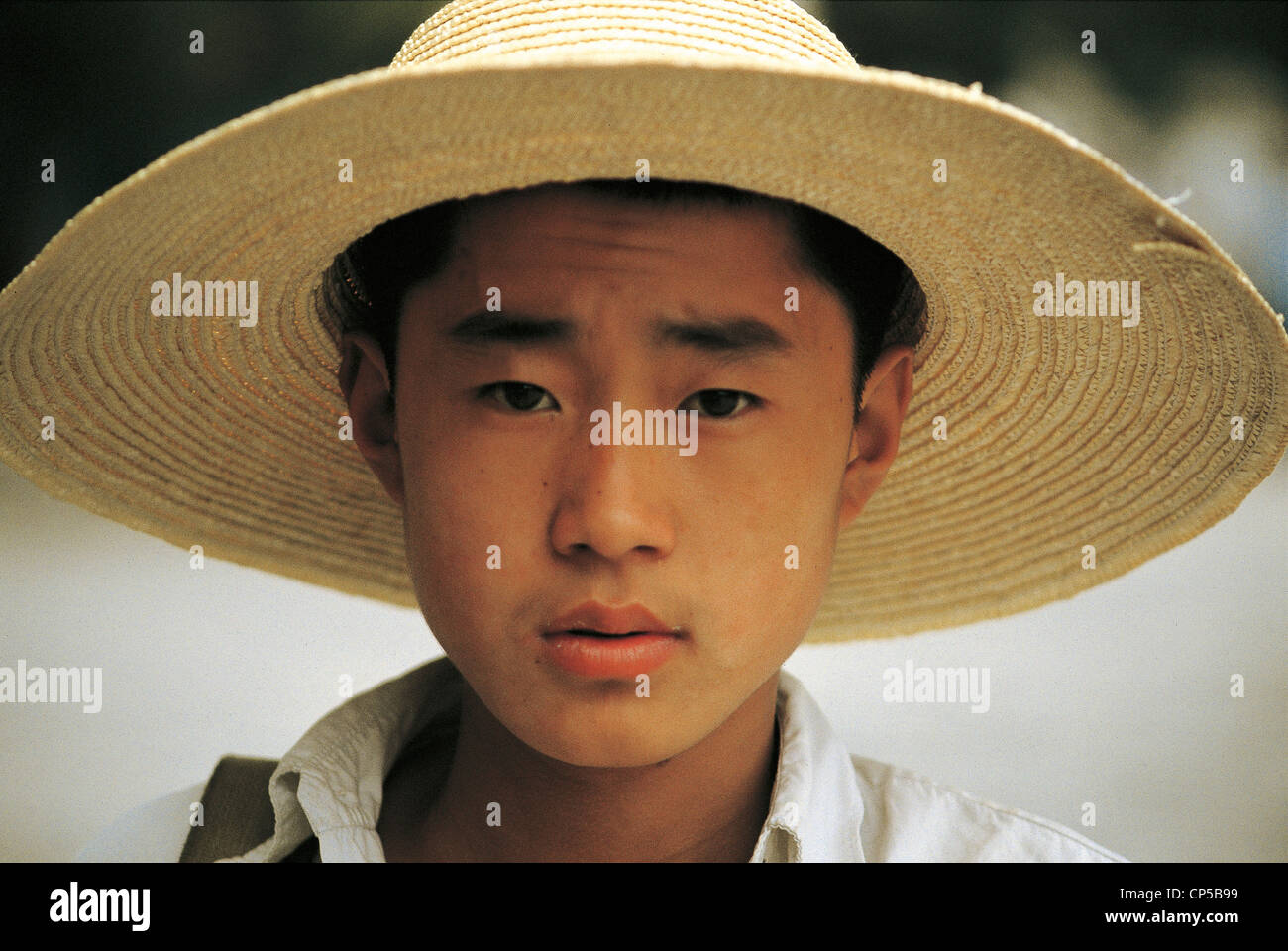 China - Boy with a straw hat Stock Photo - Alamy