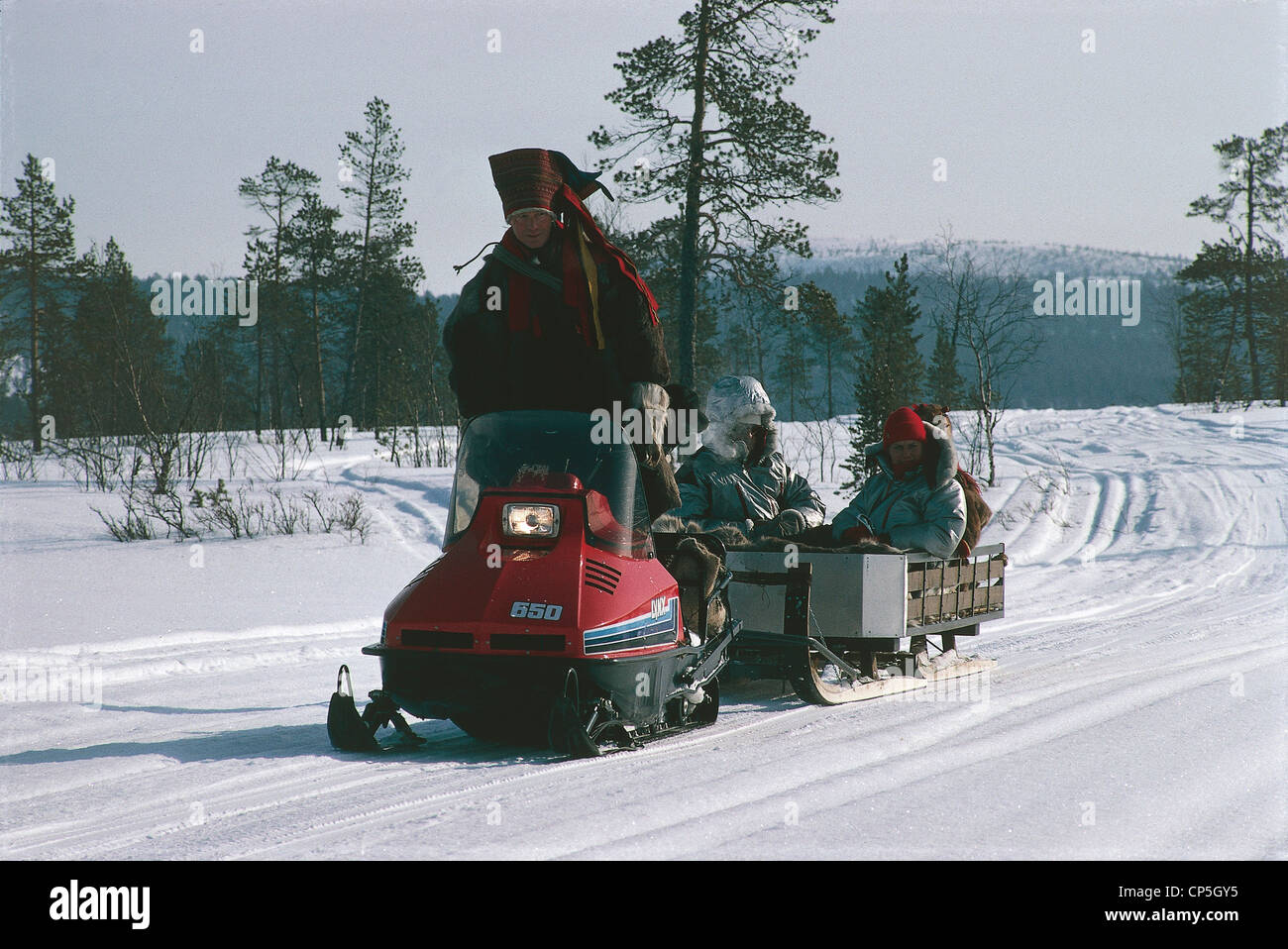Finland - Inari - Men Sami riding a snowmobile Stock Photo - Alamy