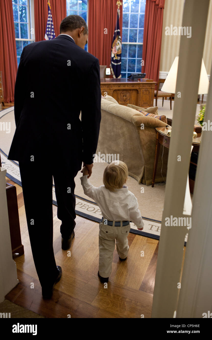 President Barack Obama walks into the Oval Office with William Jones ...