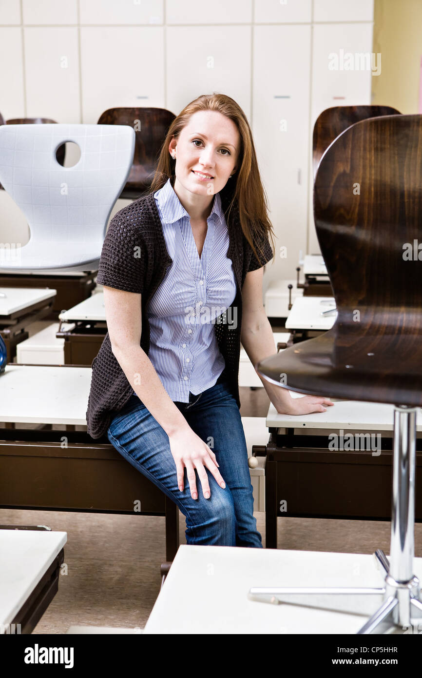 portrait of a young female teacher in the classroom Stock Photo - Alamy