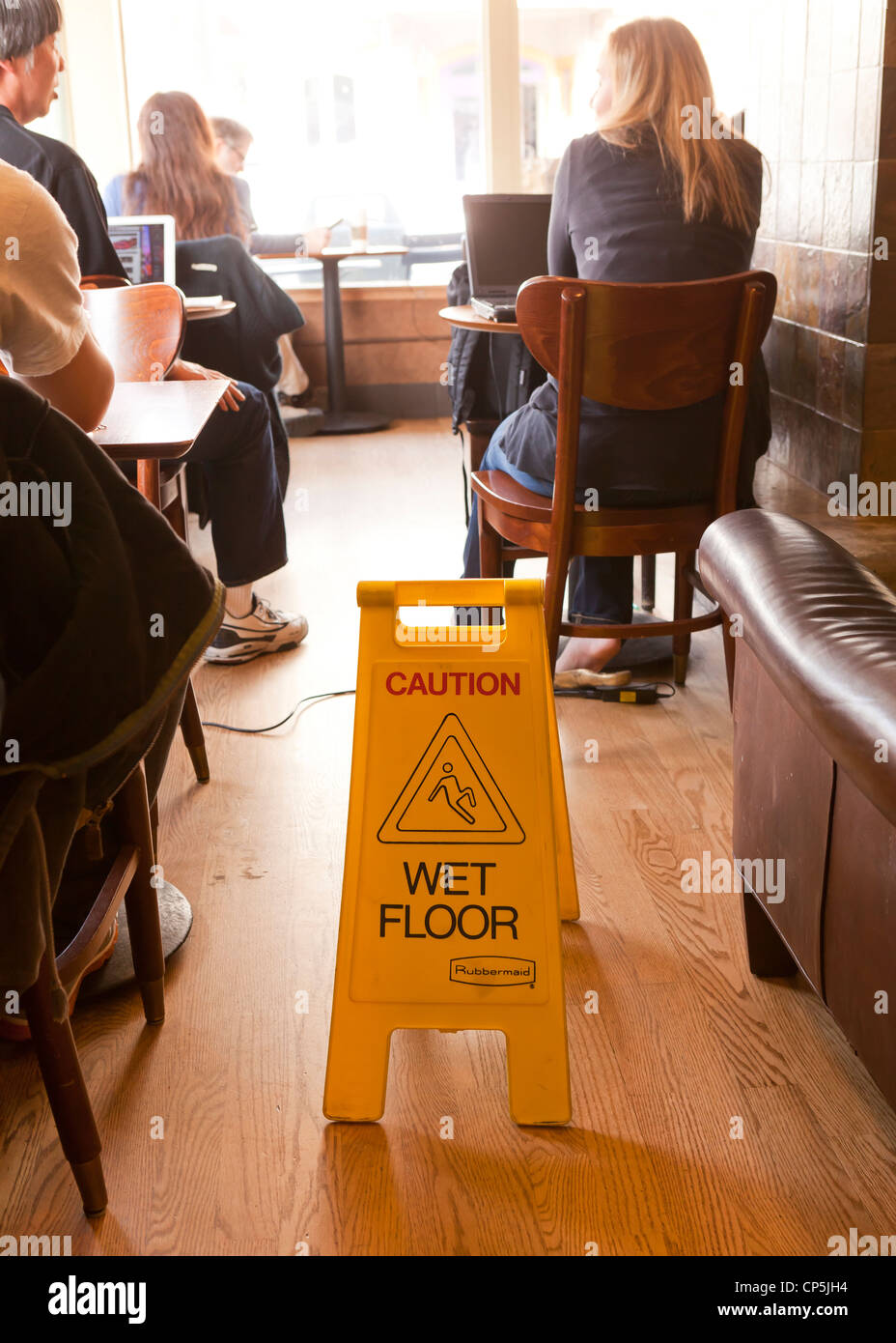Wet floor safety sign in coffee shop Stock Photo - Alamy