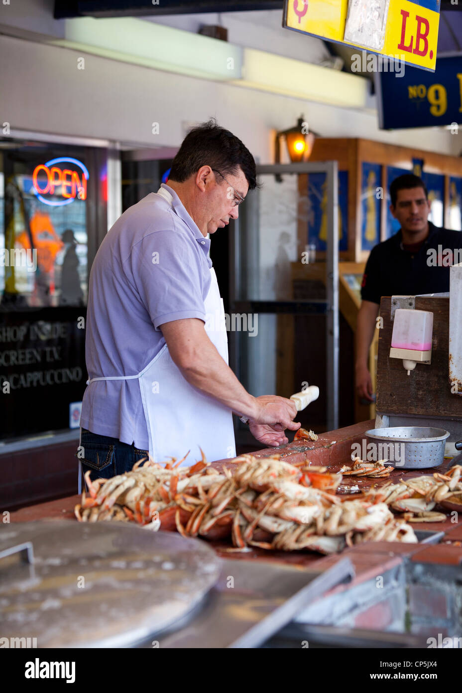 A man cracking crabs Stock Photo - Alamy