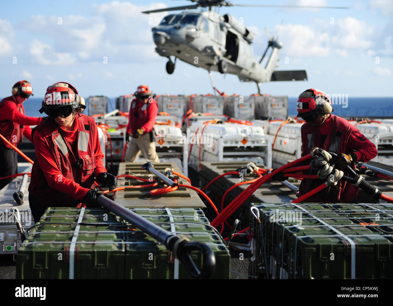 Aviation Ordnanceman Airman Kaley R. Vercande rigs a sling on the ...