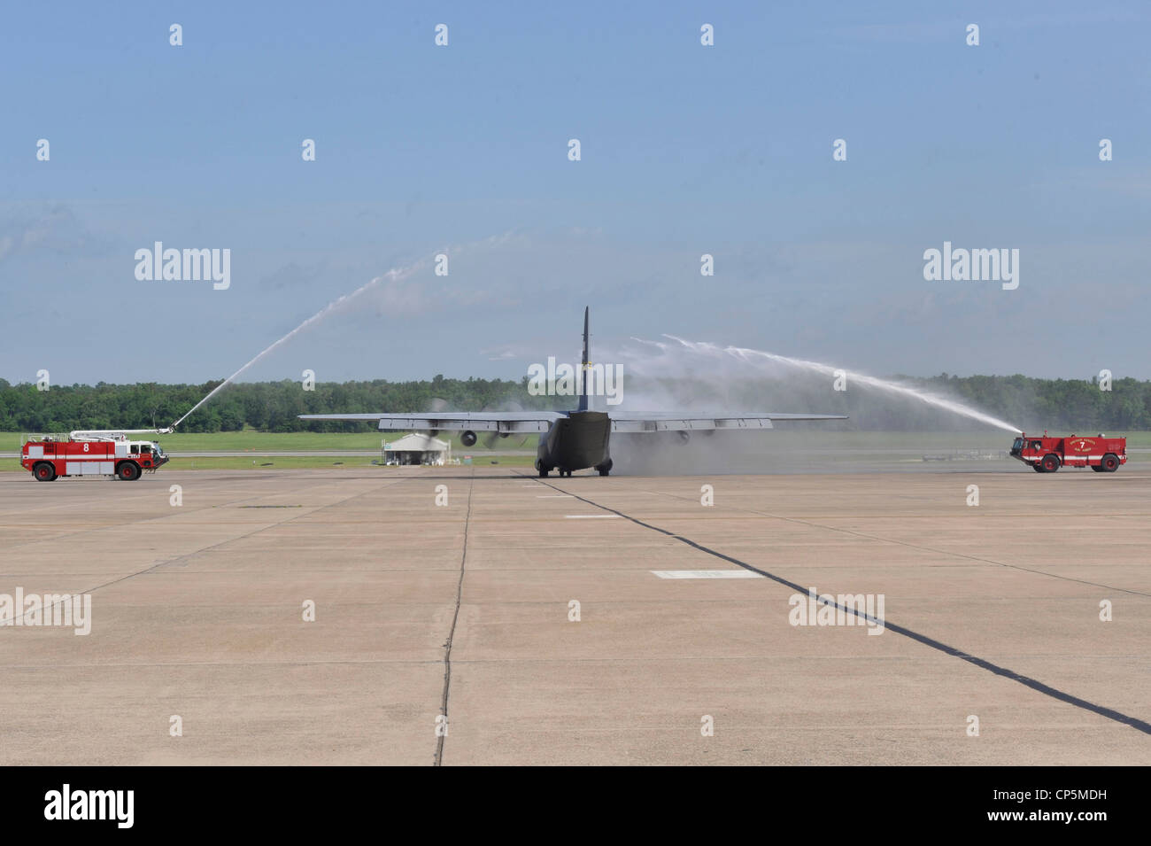 C-130E 61-2358 gets washed down by fire trucks as it taxies down the ...