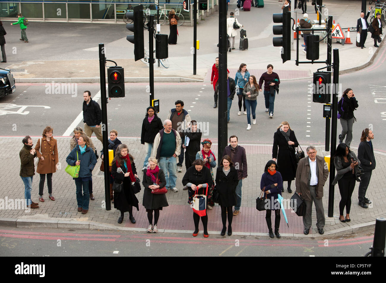 Pedestrians at a crossing in Kings Cross, London, UK Stock Photo - Alamy