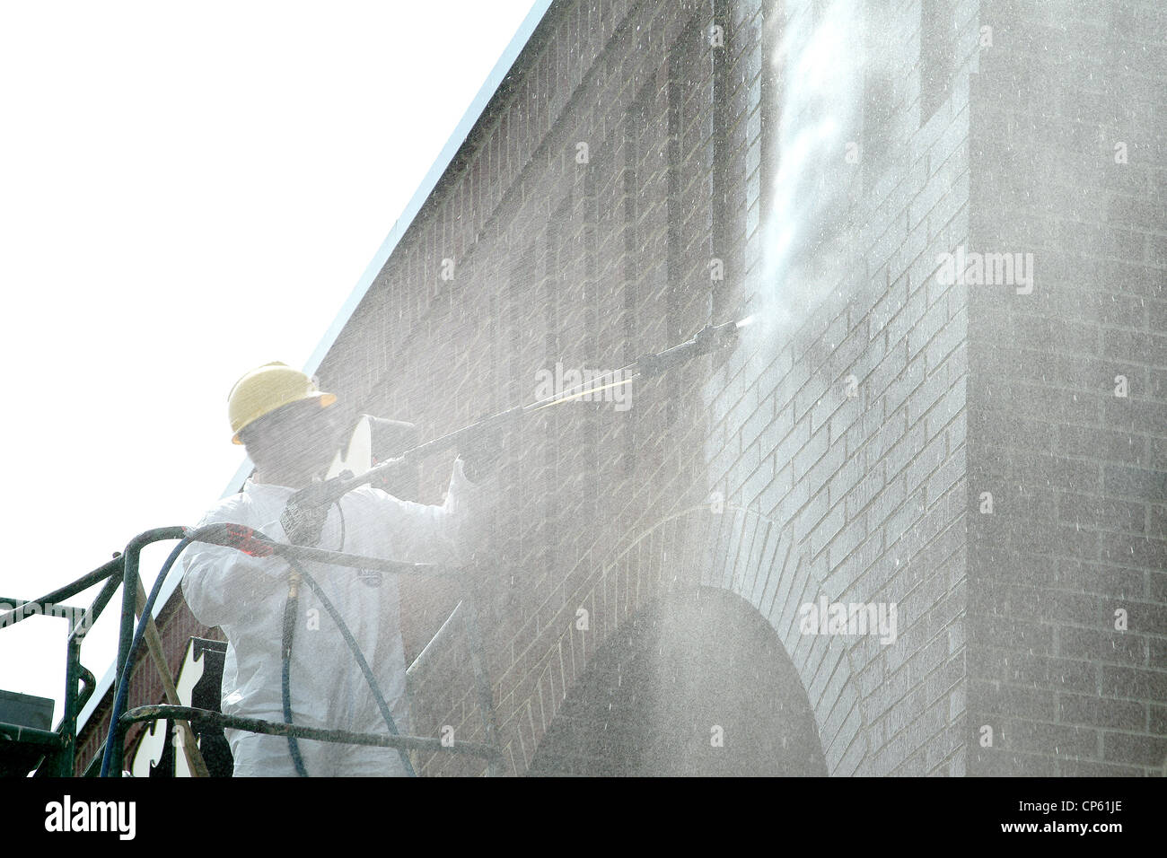 Man power washing building Stock Photo - Alamy