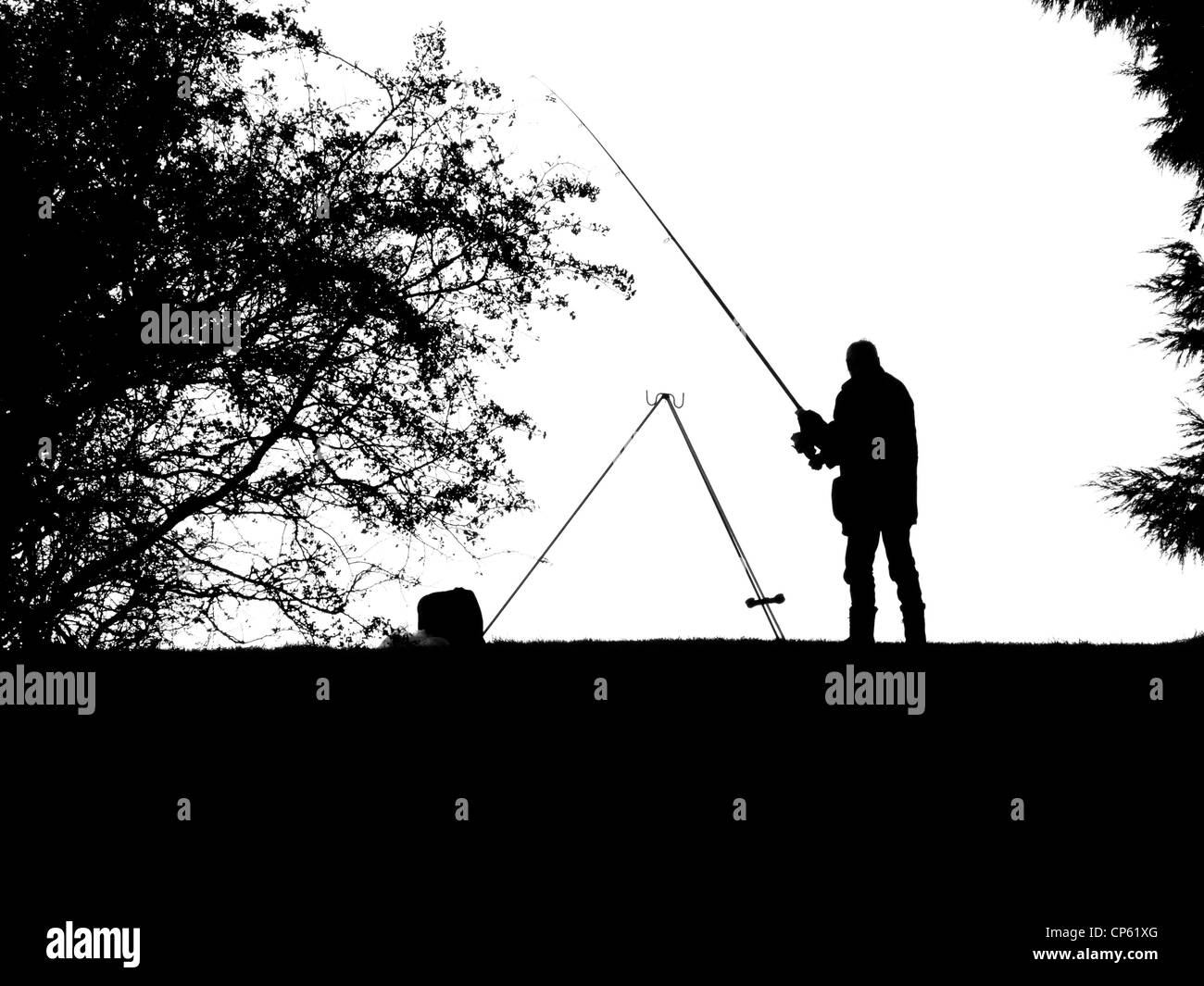 Silhouette of an angler Stock Photo - Alamy