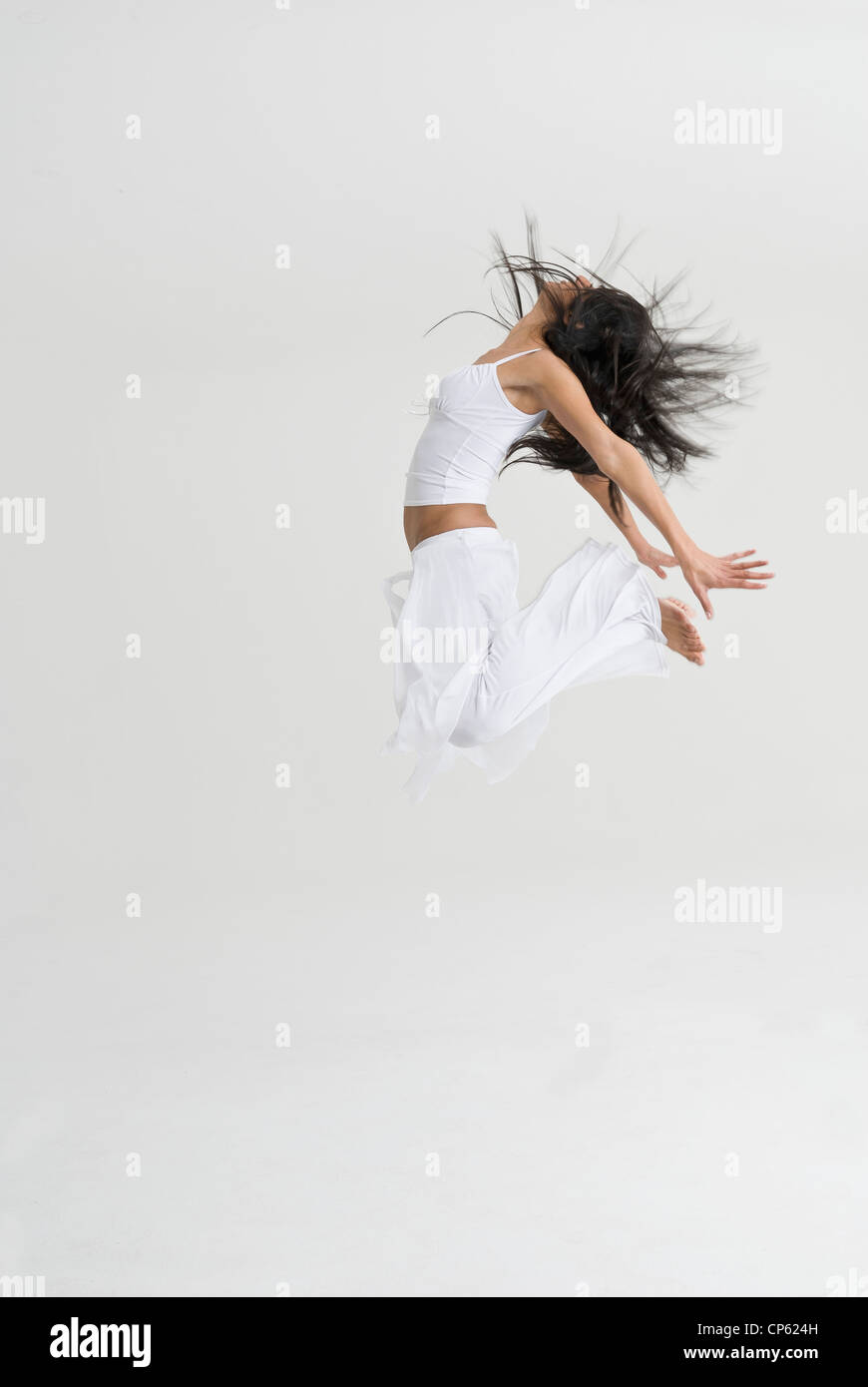 Young woman jumping and dancing Stock Photo - Alamy