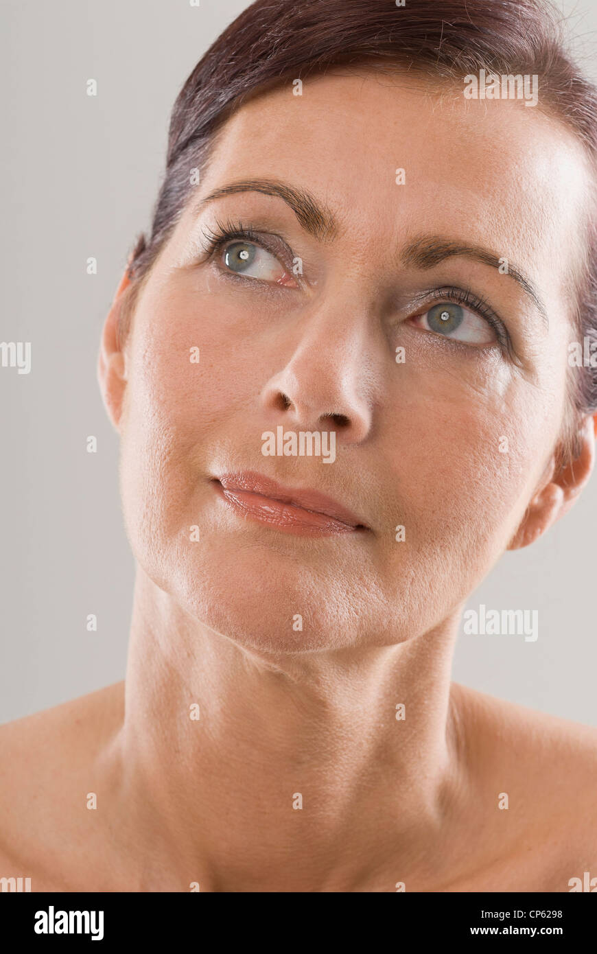 Mature woman looking up, close up Stock Photo - Alamy