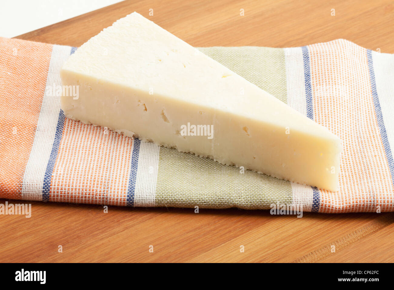 Italian hard cheese with towel on table, close up Stock Photo - Alamy
