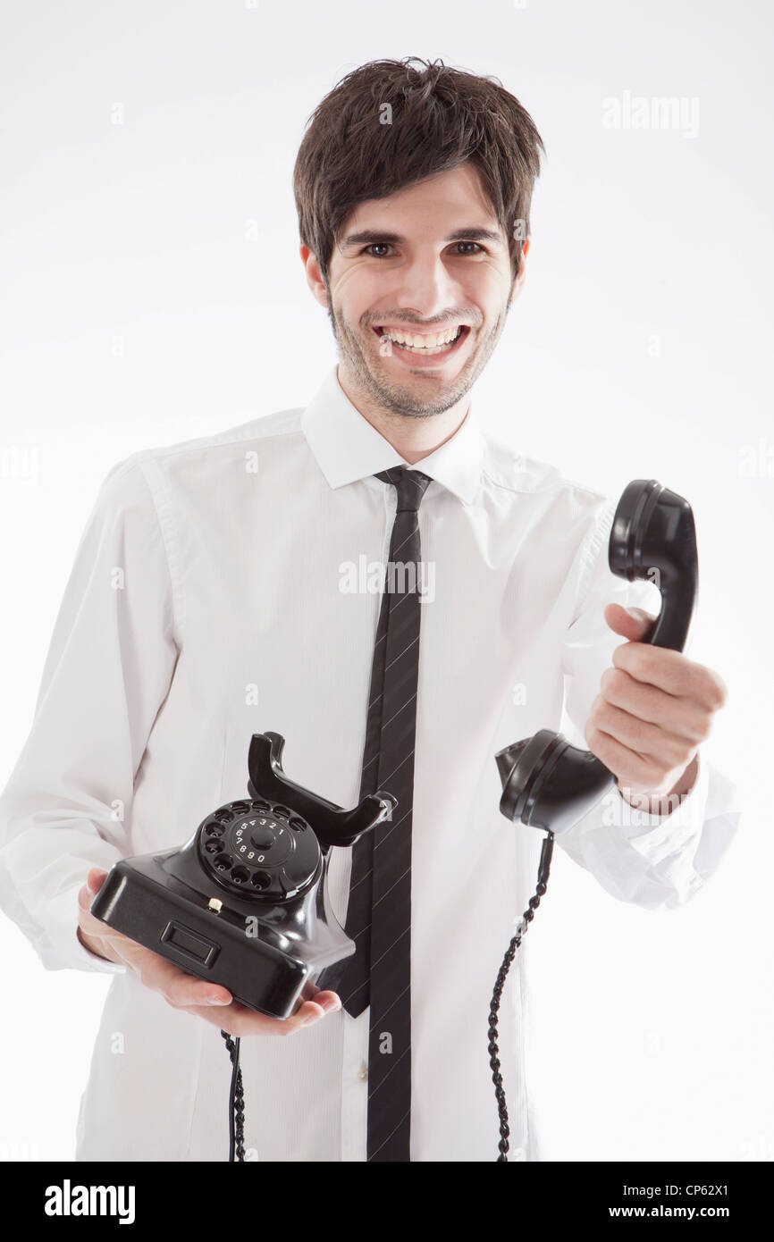 Young man with antique telephone, smiling, portrait Stock Photo - Alamy