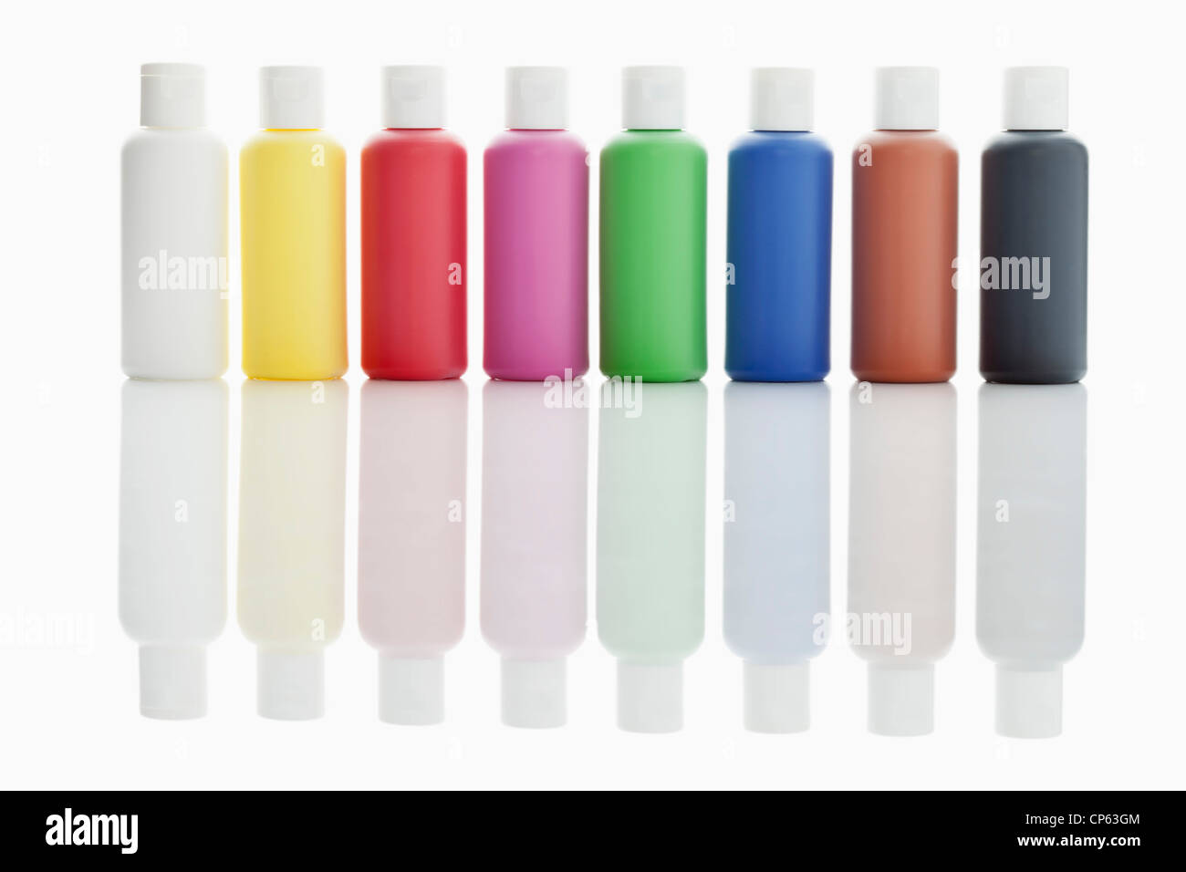 Row of acrylic color bottles on white background Stock Photo - Alamy