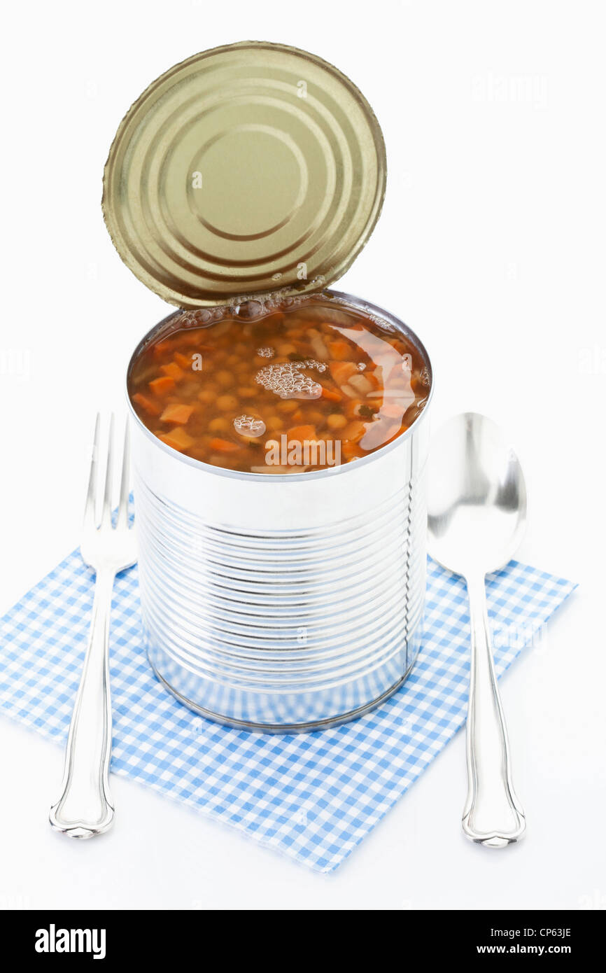 Lentil in tin with fork and spoon on white background Stock Photo - Alamy