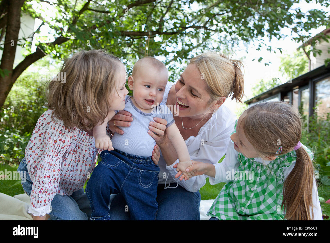 Germany, Bavaria, Munich, Family in garden, smiling Stock Photo - Alamy