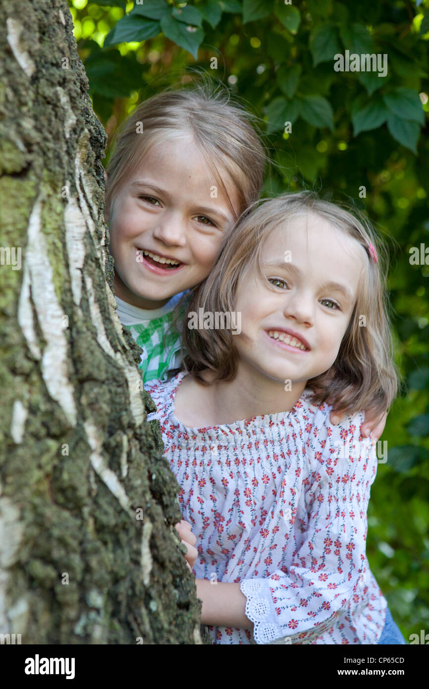 Germany, Bavaria, Munich, Girls in garden, smiling, portrait Stock ...