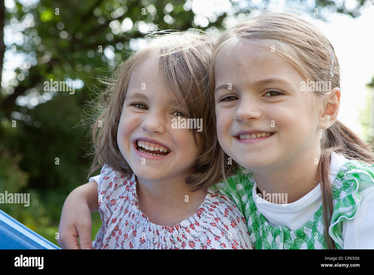 Germany, Bavaria, Munich, Girls in garden, smiling, portrait Stock ...