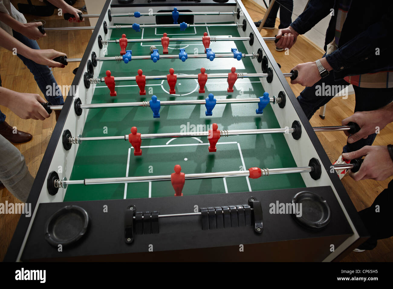 Germany, Cologne, Men and women playing table soccer Stock Photo - Alamy