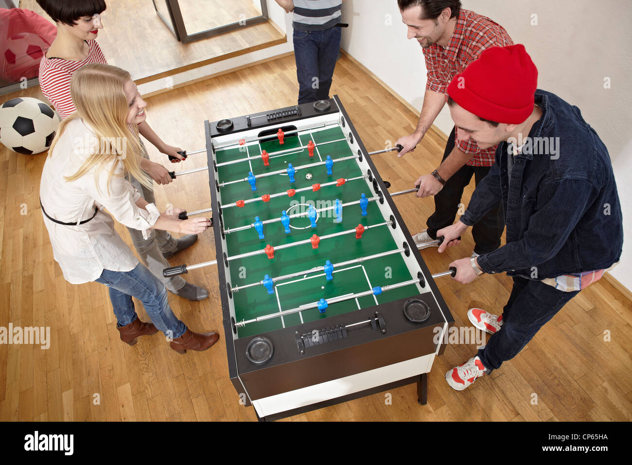 Germany, Cologne, Men and women playing table soccer Stock Photo - Alamy