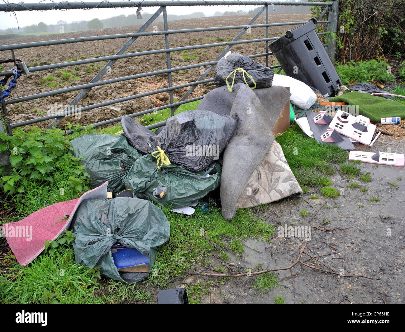 Fly tipping tip in gateway in UK countryside Stock Photo - Alamy