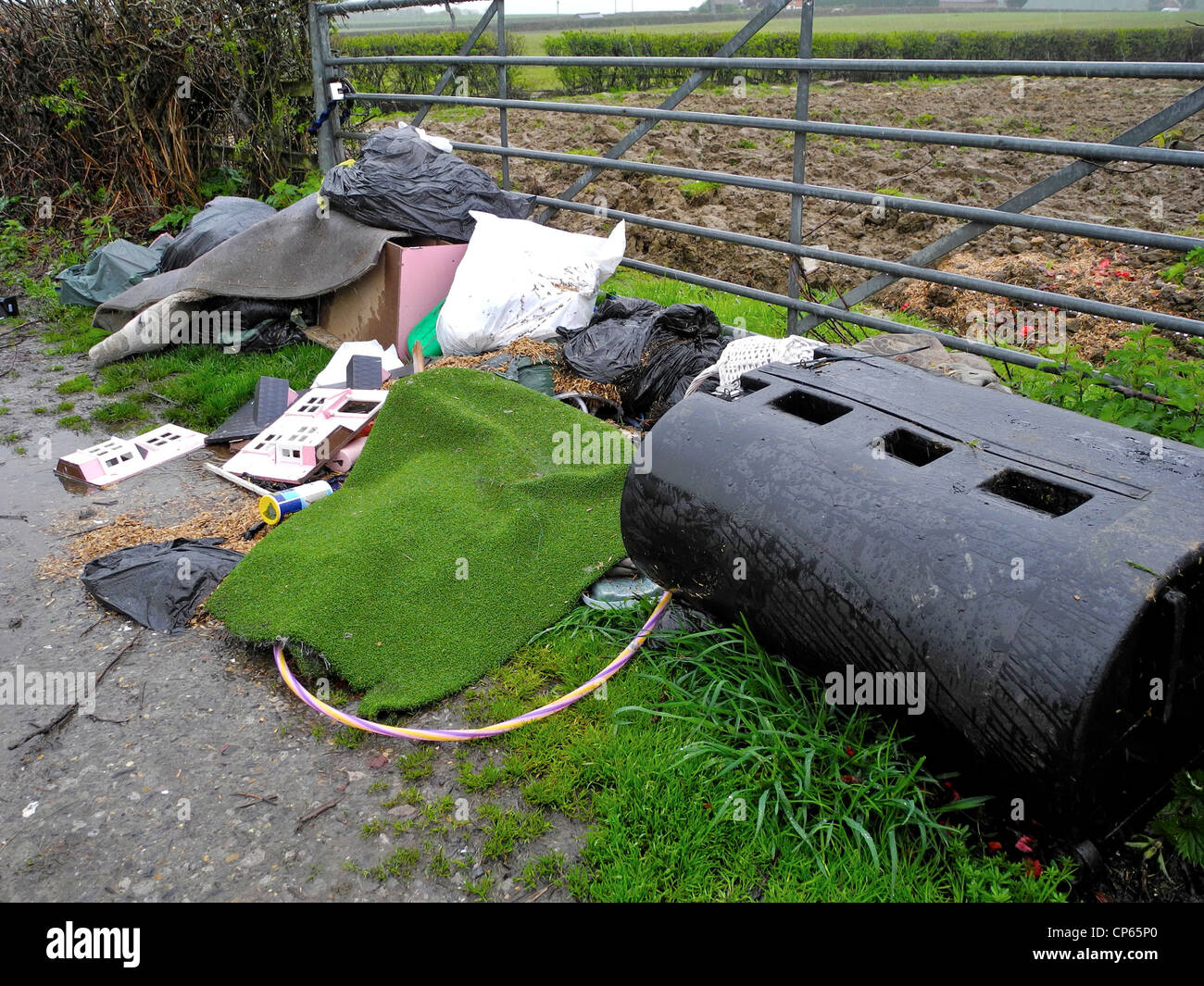 Fly tipping tip in gateway in UK countryside Stock Photo - Alamy