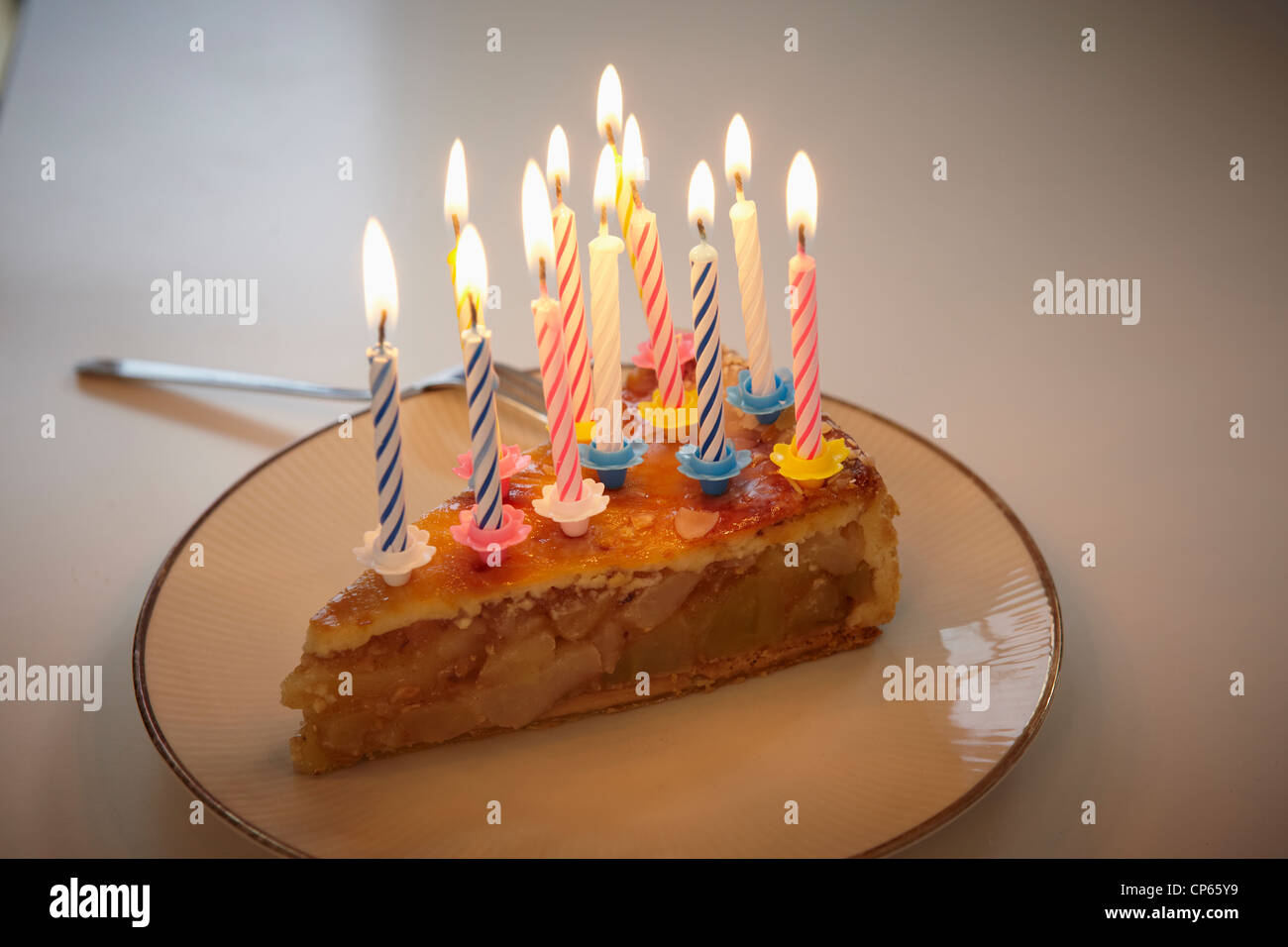 Germany, Cologne, Birthday cake with candles in apartment Stock Photo ...