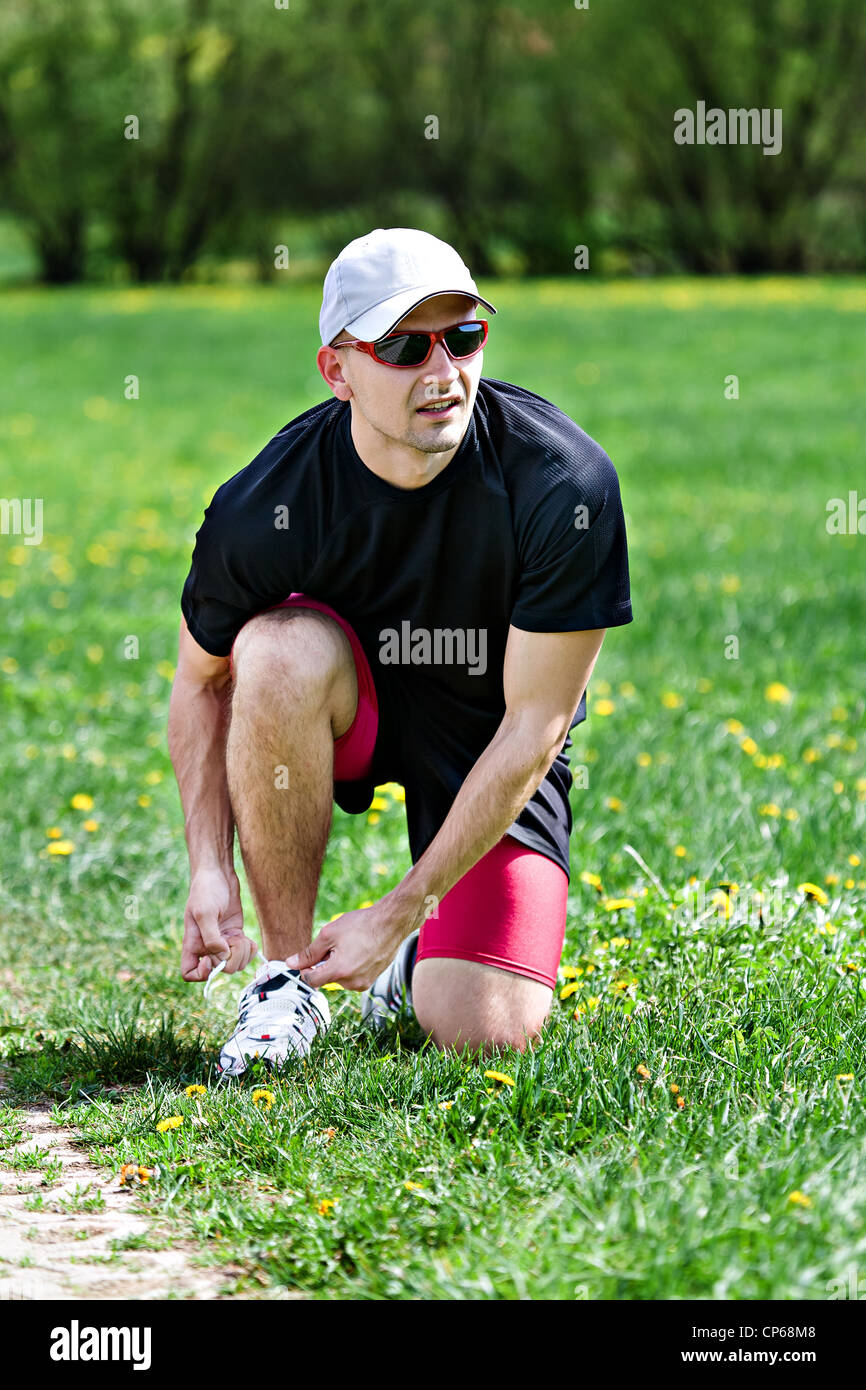 a young man jogging through the fields Stock Photo - Alamy
