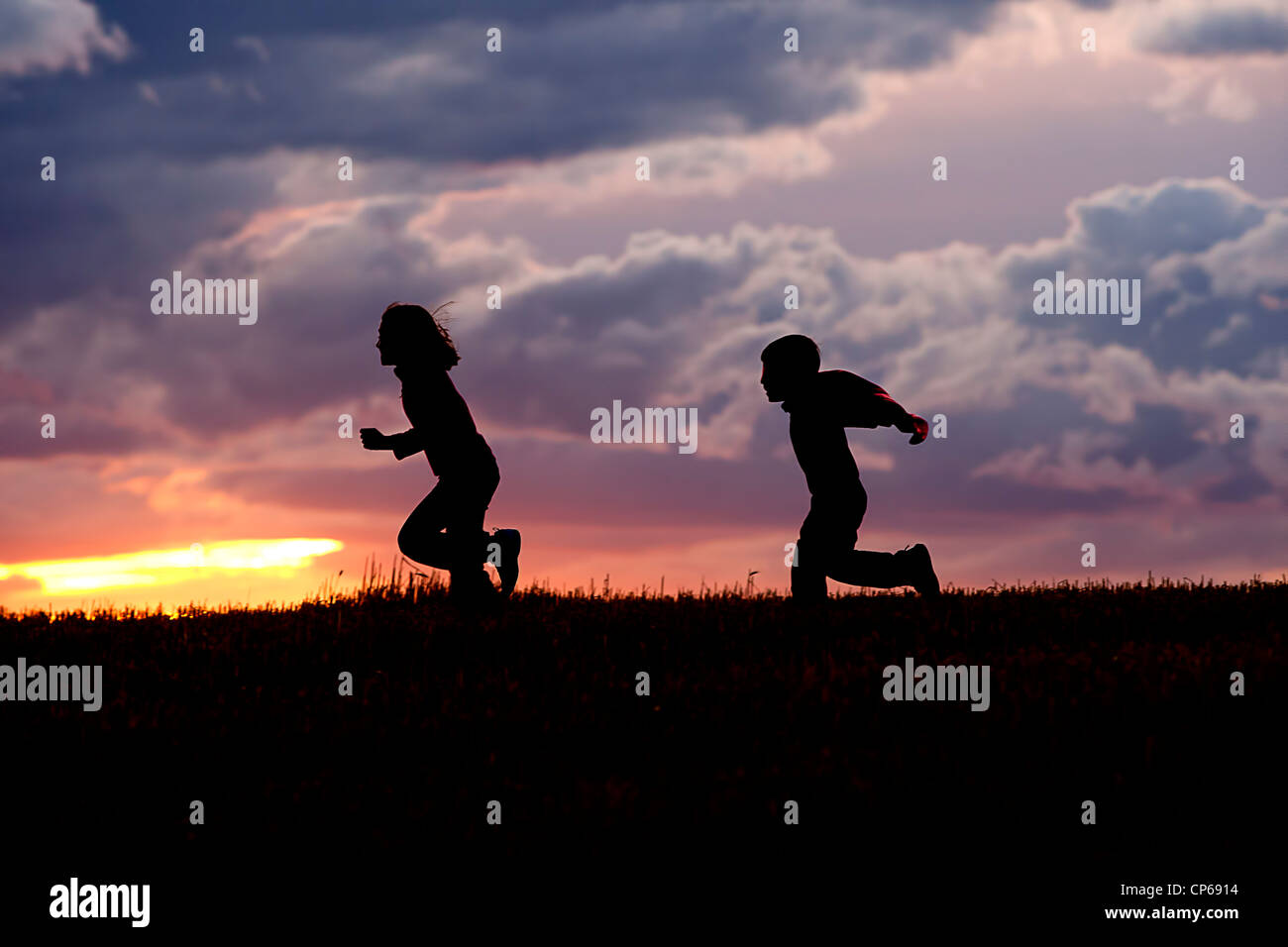 Kids running at sunset Stock Photo - Alamy
