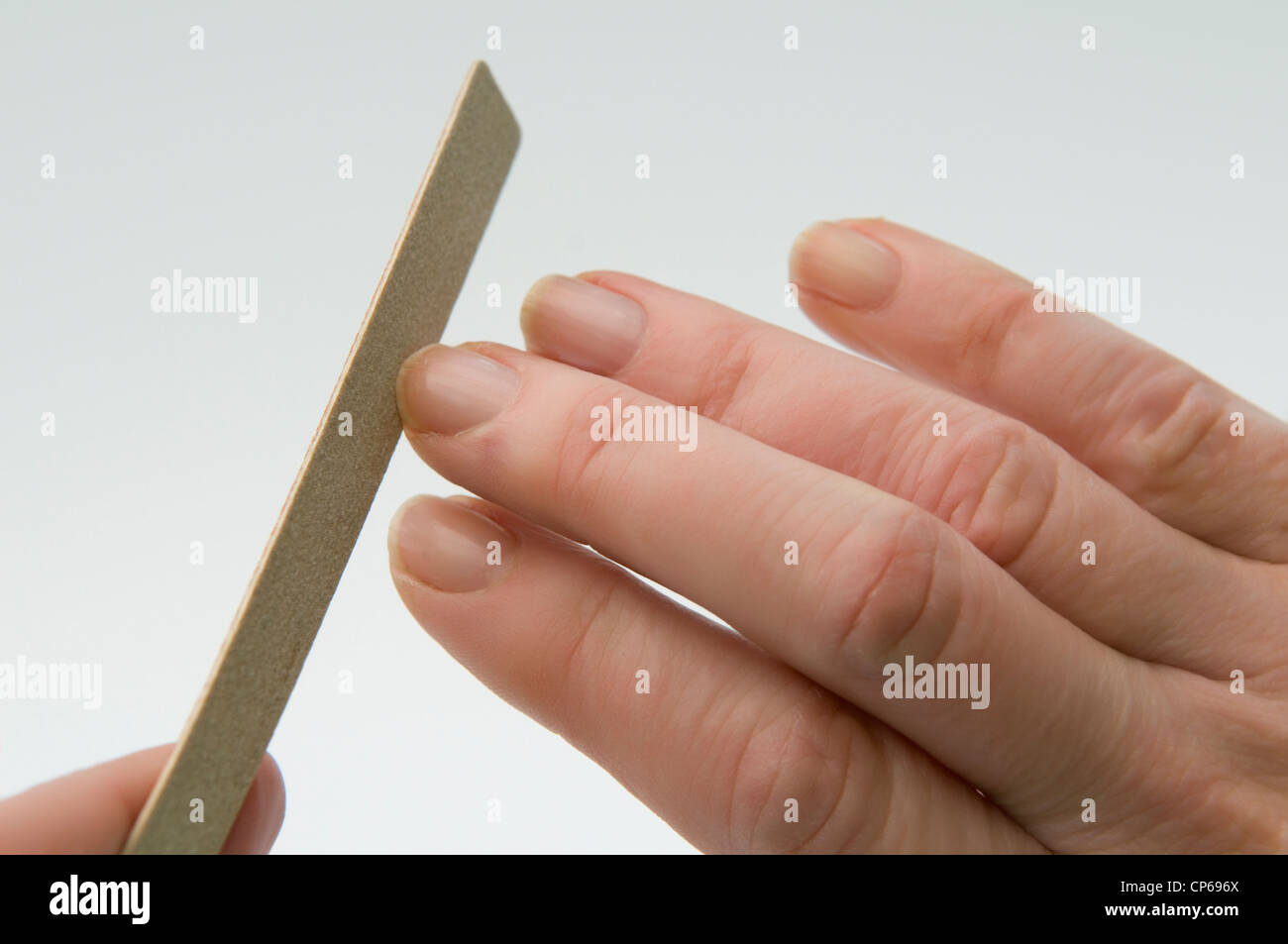 Hand shot of Caucasian woman filing nails Stock Photo - Alamy