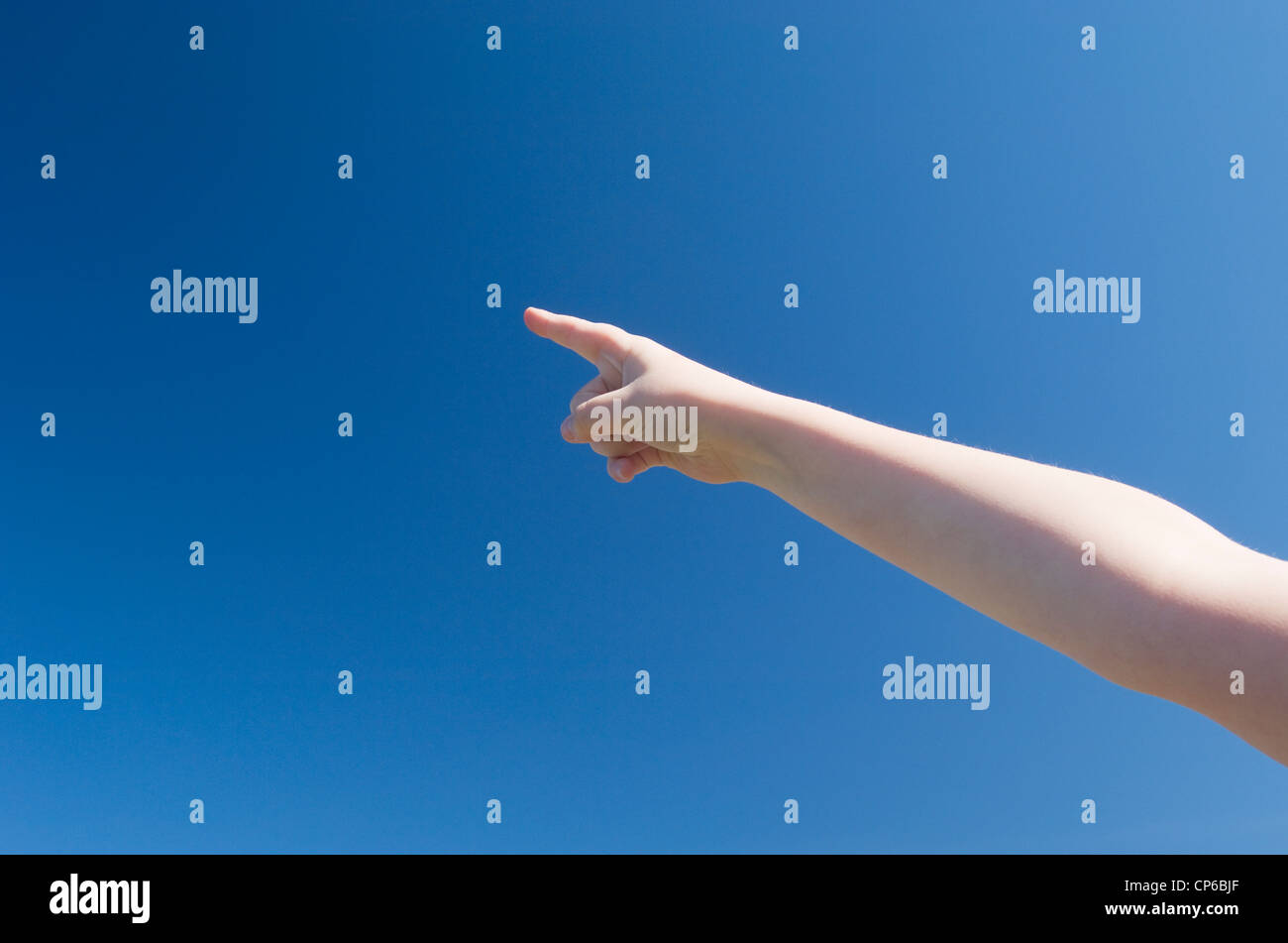 Hand pointing against a clear blue sky Stock Photo - Alamy