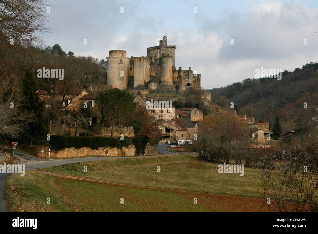 the Chateau de Bonaguil and village below near Fumel Lot-et-Garonne ...