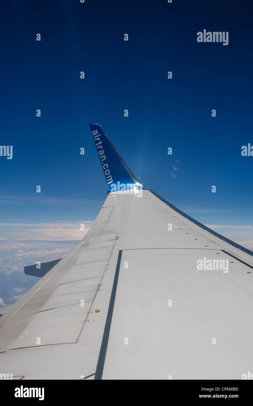 The wing of an Airtran Airlines Passenger jet high over the earth Stock ...