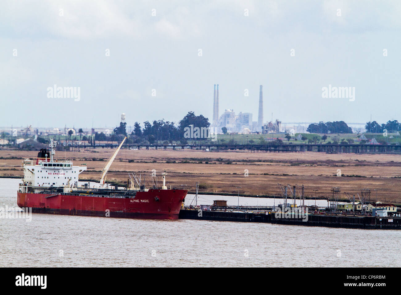 A ship in port in Martinez California with an electric power plant in ...