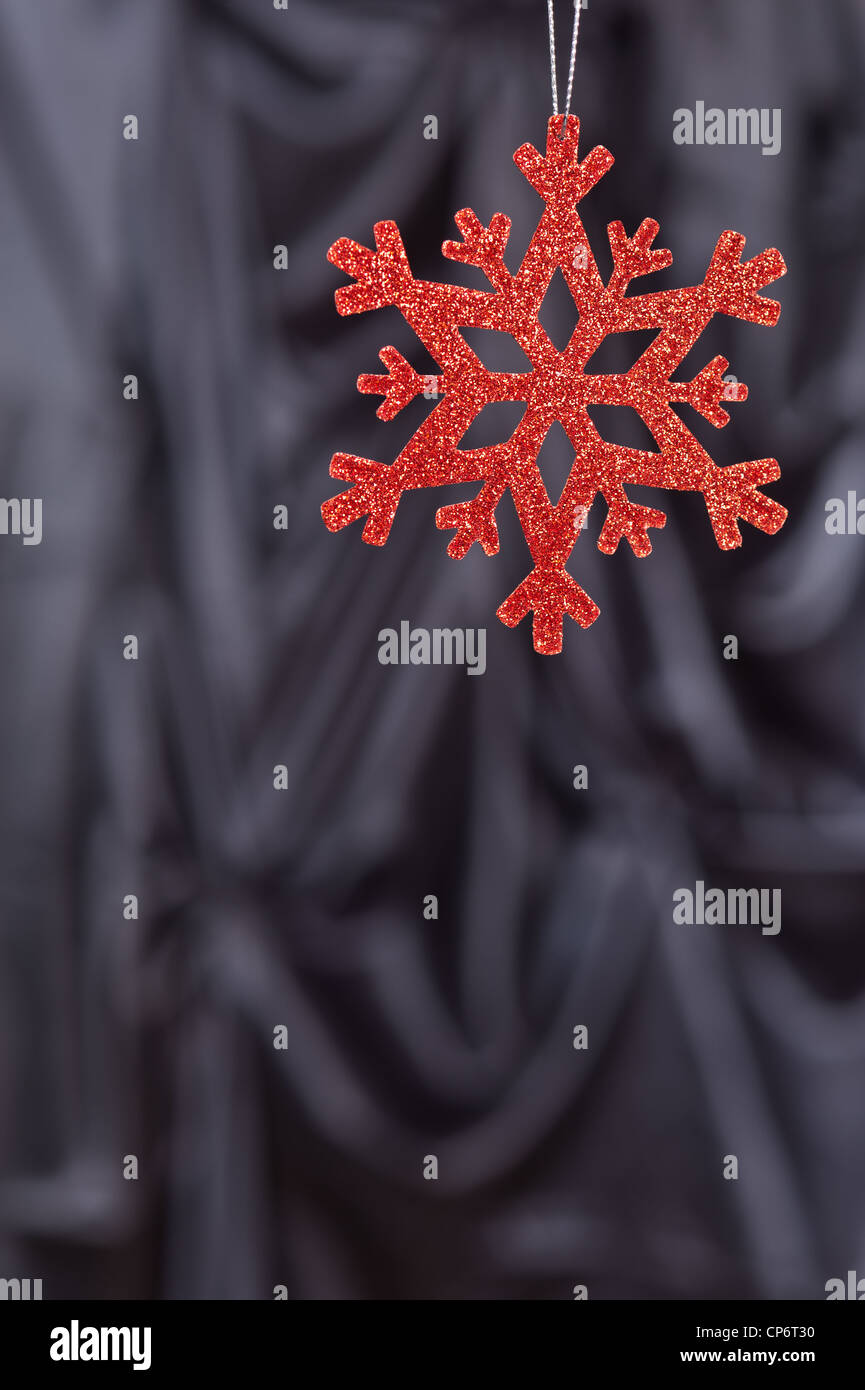 Red snow flake on a black background for Christmas Stock Photo - Alamy