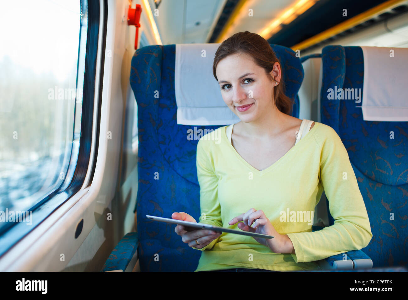 Young woman using her tablet computer while traveling by train Stock ...