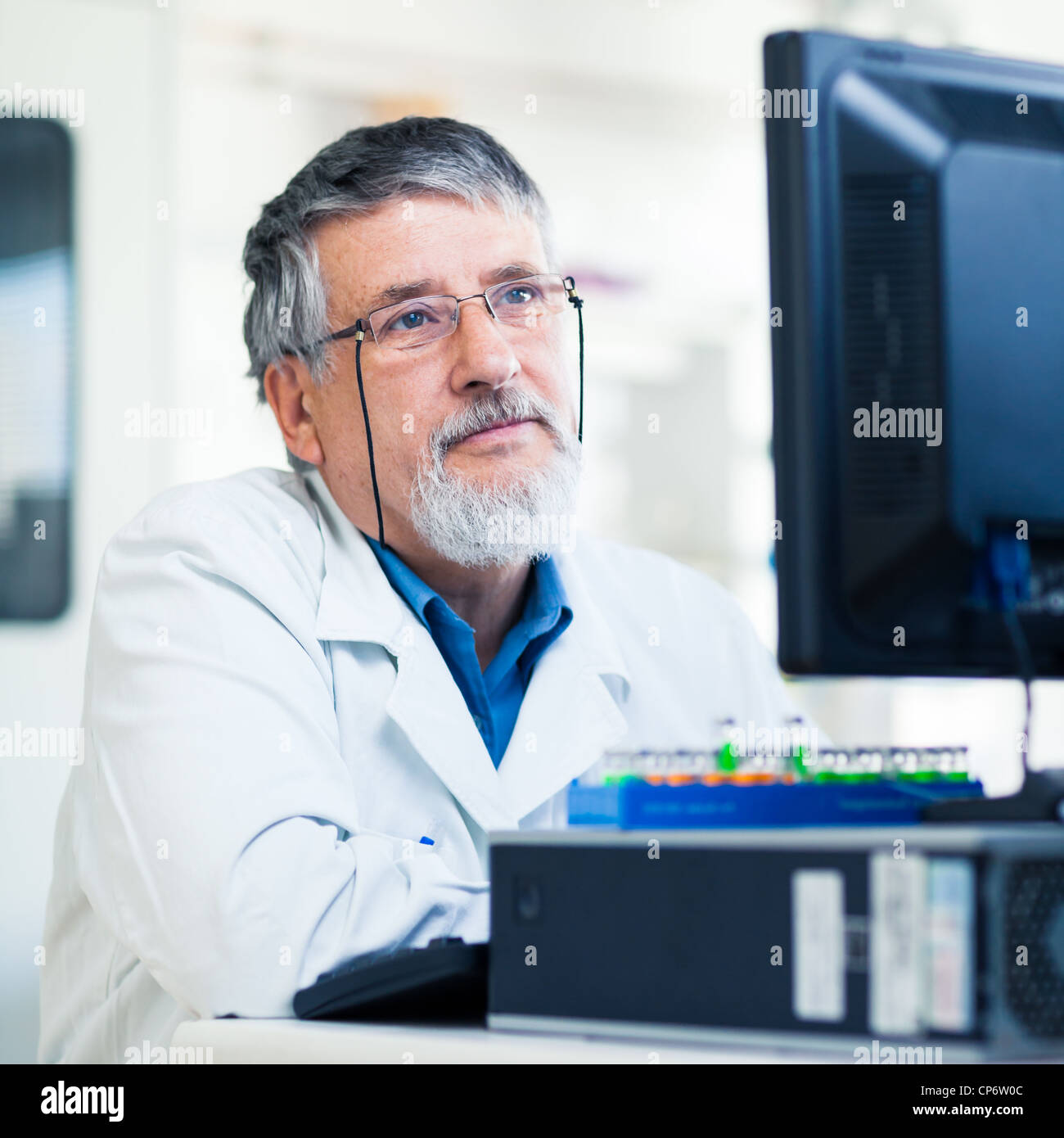 Senior researcher using a computer in the lab while working on an ...