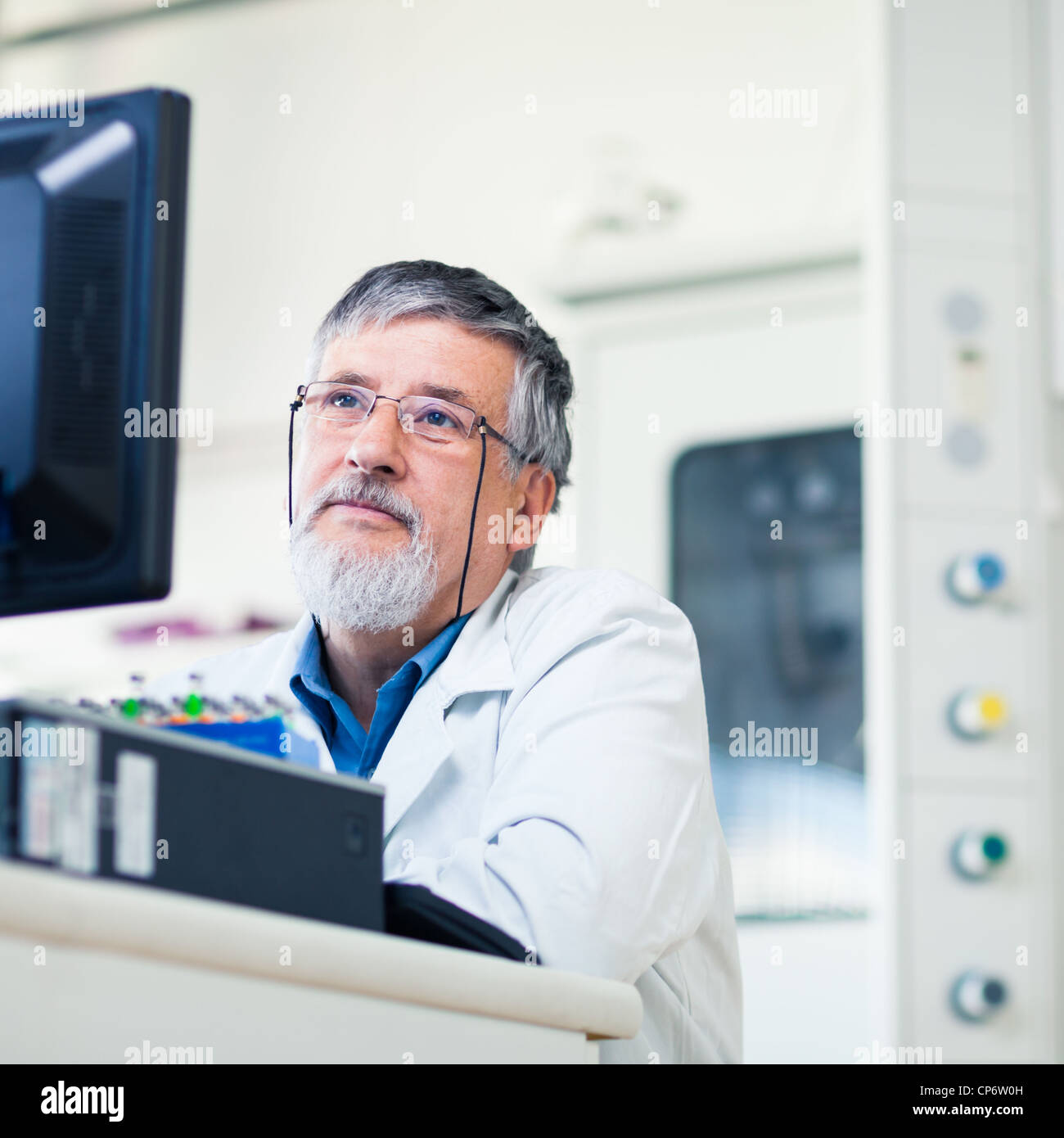 Senior researcher using a computer in the lab while working on an ...