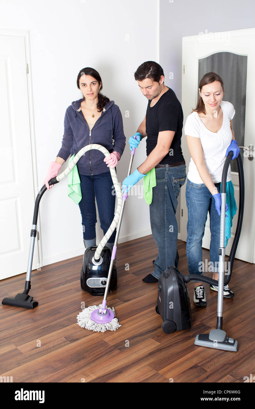 Three young people cleaning house hi-res stock photography and images ...