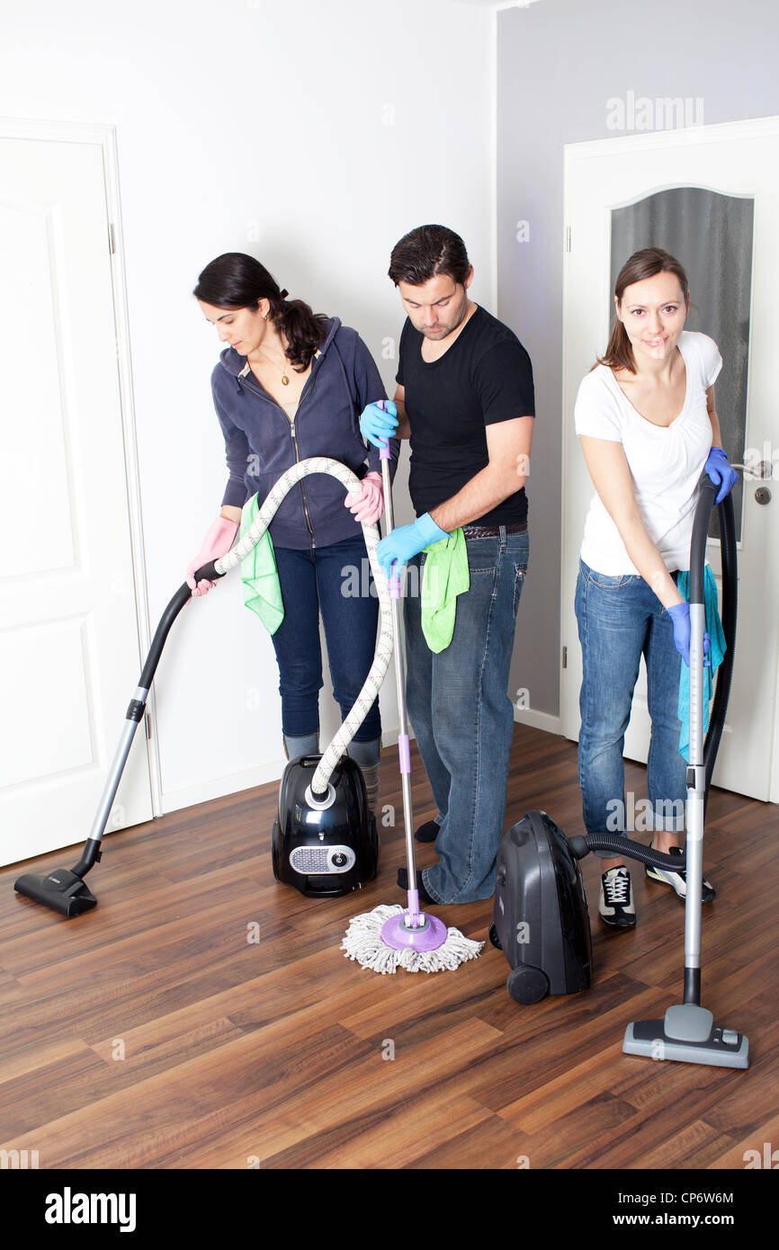 Three persons cleaning a house Stock Photo - Alamy