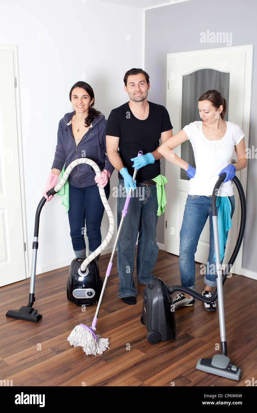 Three persons cleaning a house Stock Photo - Alamy