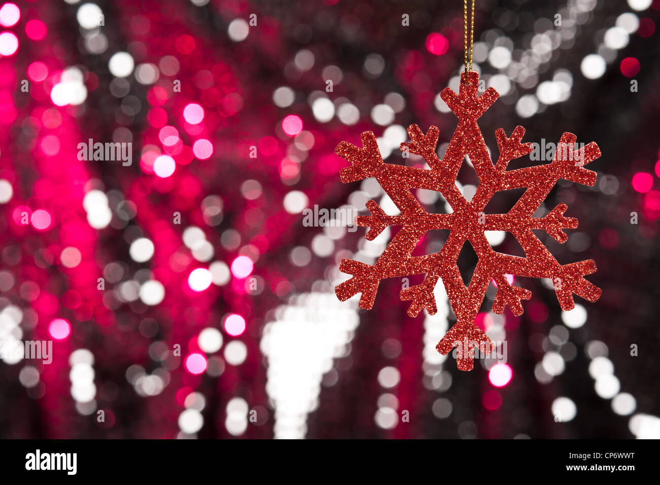 Red snow flake on a red, silver glitter background for Christmas Stock ...