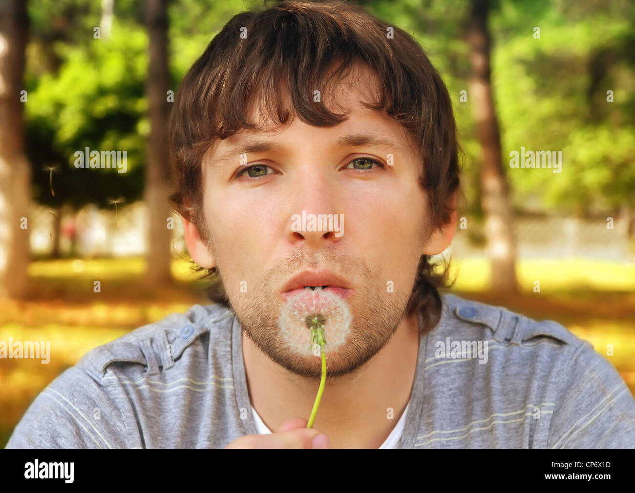 Man blowing Dandelion charming outdoor Stock Photo - Alamy